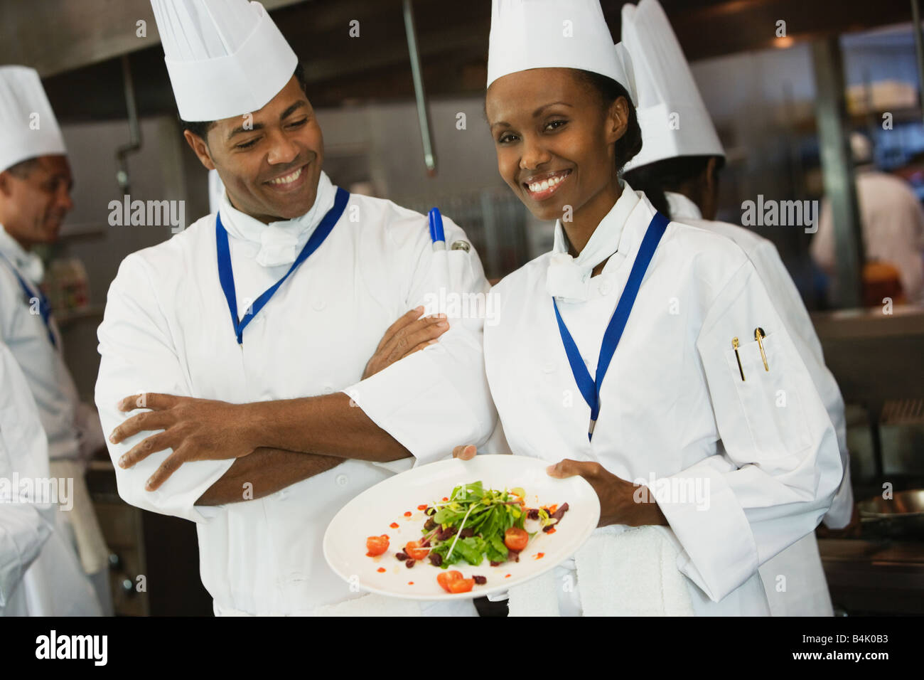 Smiling female chef posing hi-res stock photography and images - Alamy