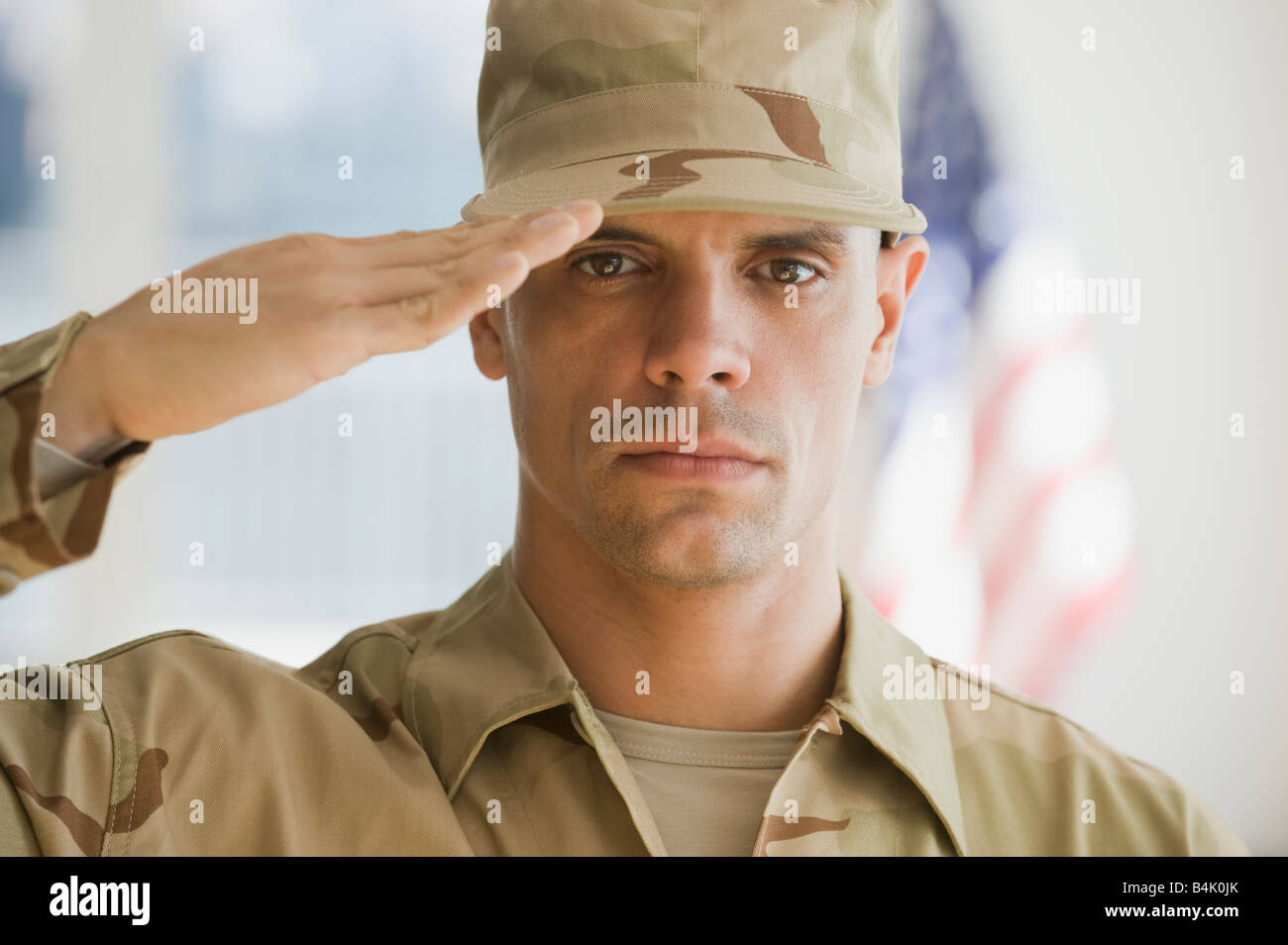 Hispanic male soldier saluting Stock Photo - Alamy