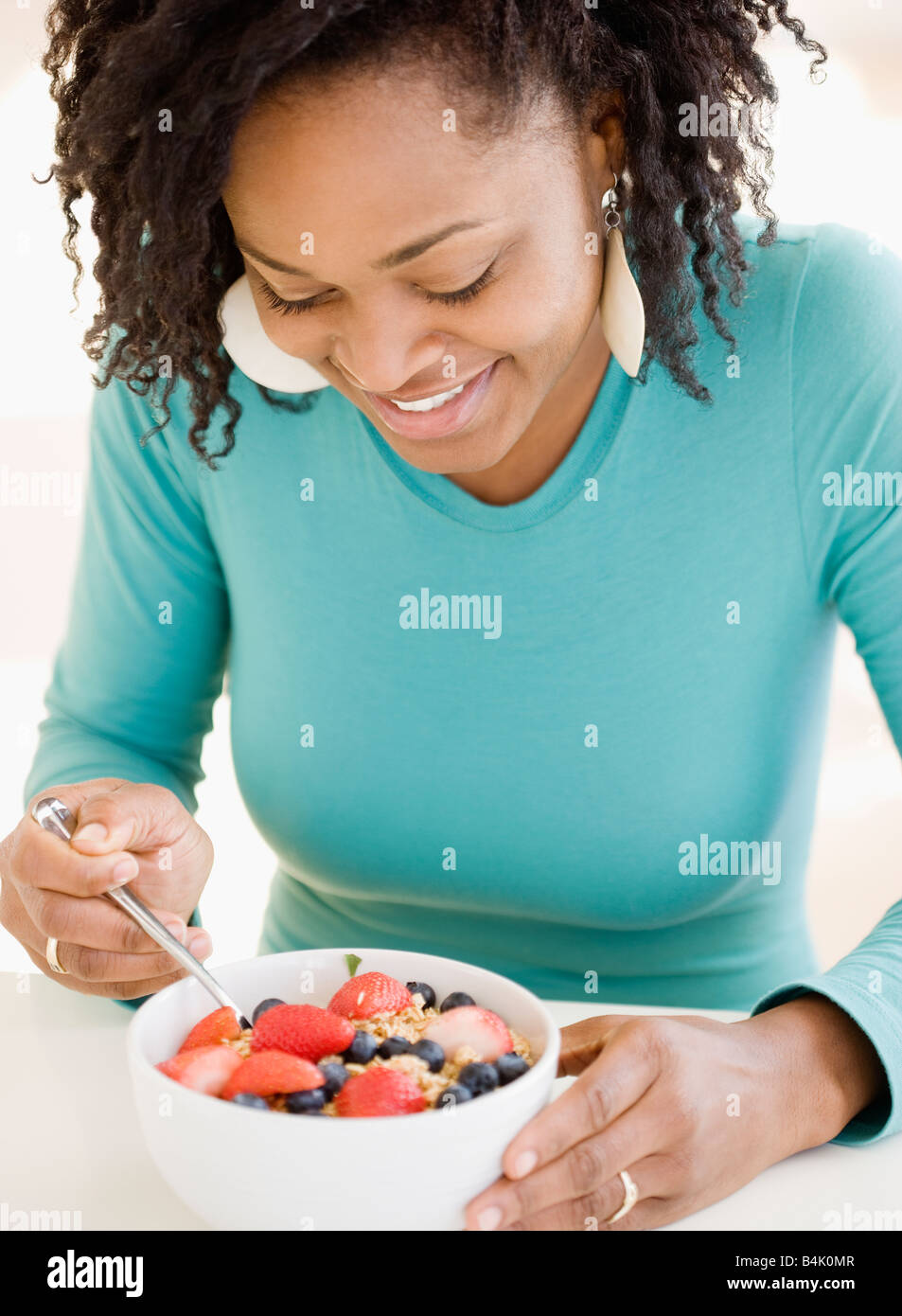 African woman eating cereal Stock Photo - Alamy