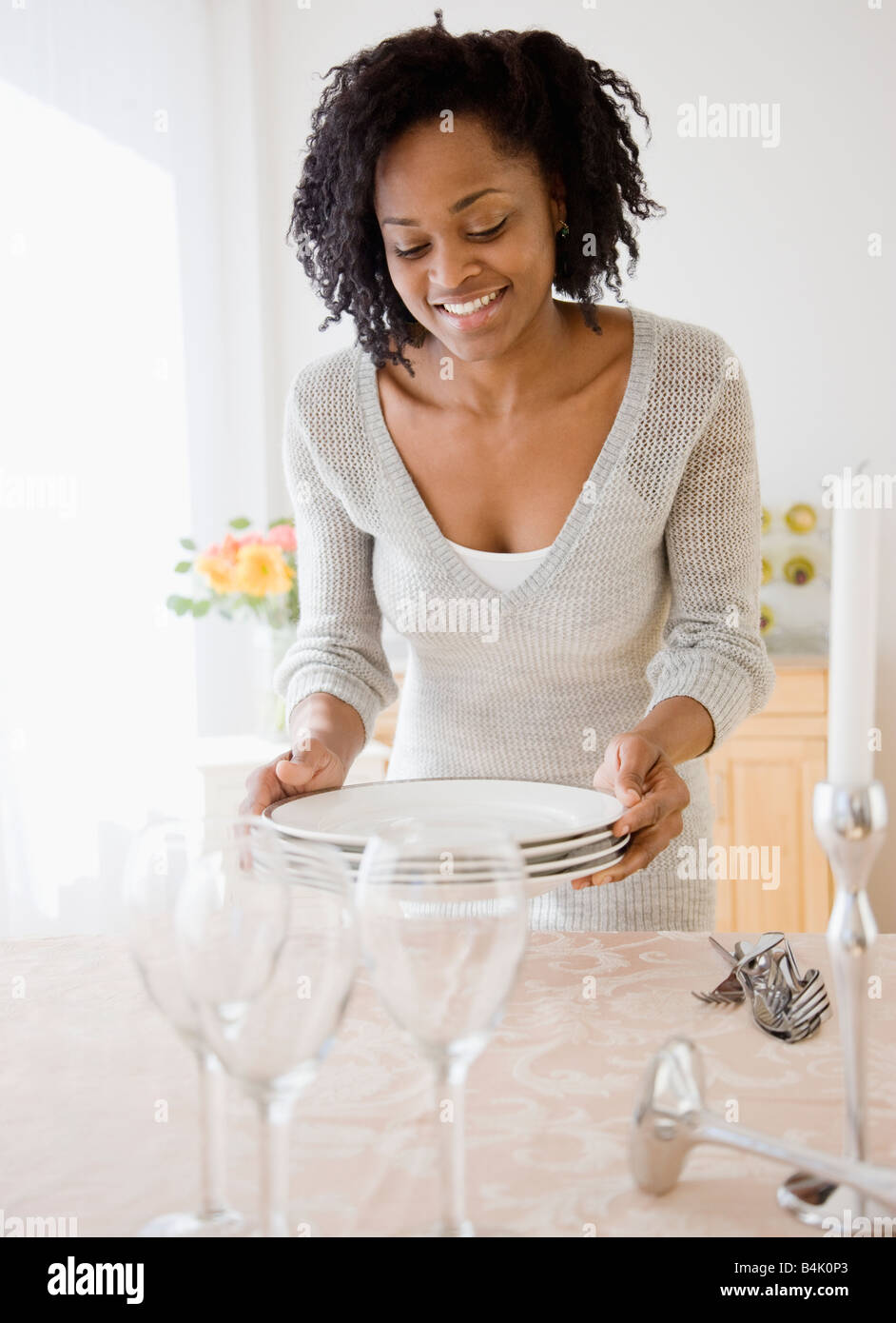 African woman carrying stack of plates Stock Photo - Alamy