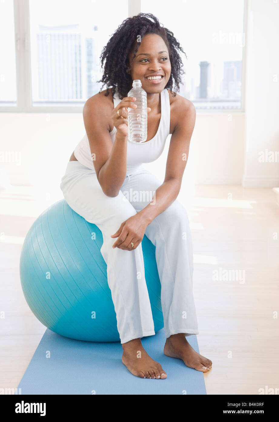 African woman sitting on exercise ball Stock Photo - Alamy