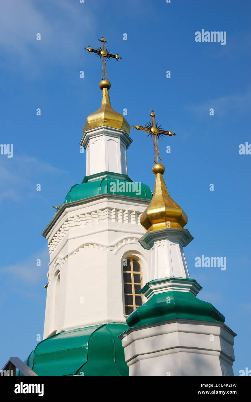 Towers of orthodox church with golden cupolas and cyan roofs against ...