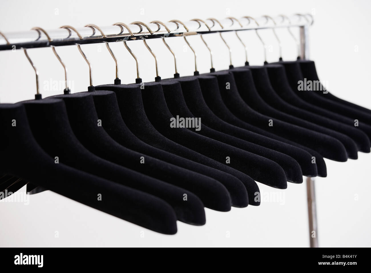 Row of empty clothing hangers on rack Stock Photo - Alamy