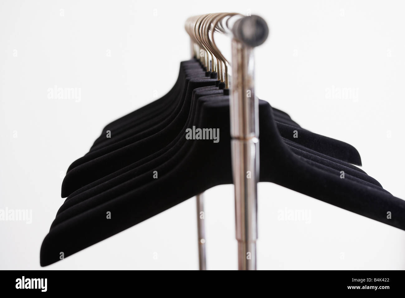 Row of empty clothing hangers on rack Stock Photo - Alamy