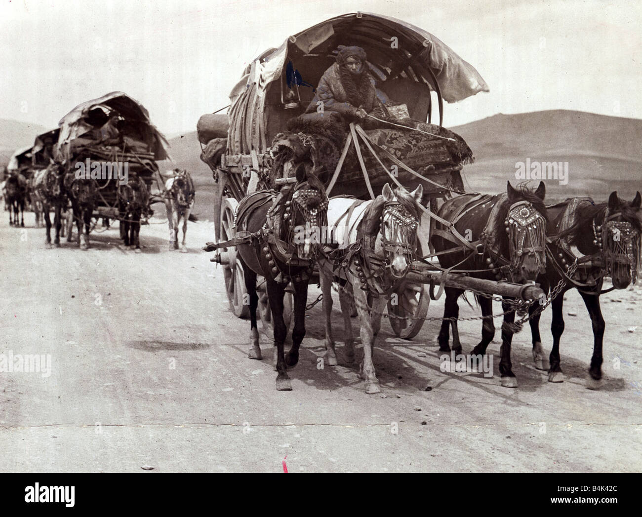 Nomads driving theor wagons along the dusty road towards Tehran Caravan ...
