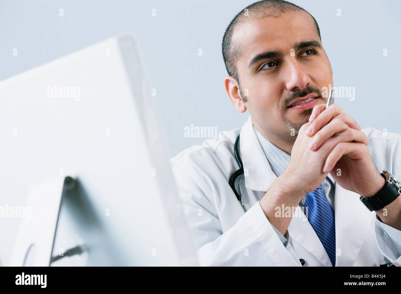 Lebanese male doctor thinking Stock Photo - Alamy