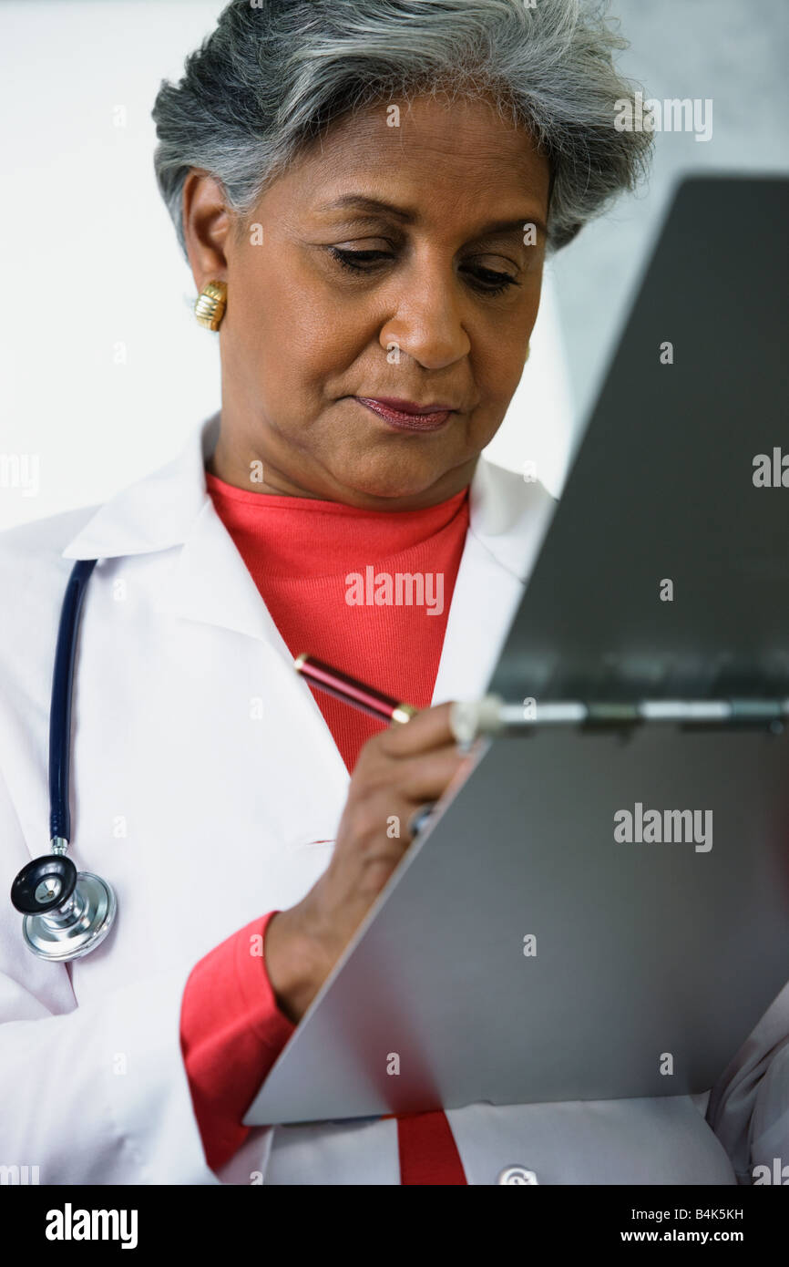Female doctor writing chart in hi-res stock photography and images - Alamy