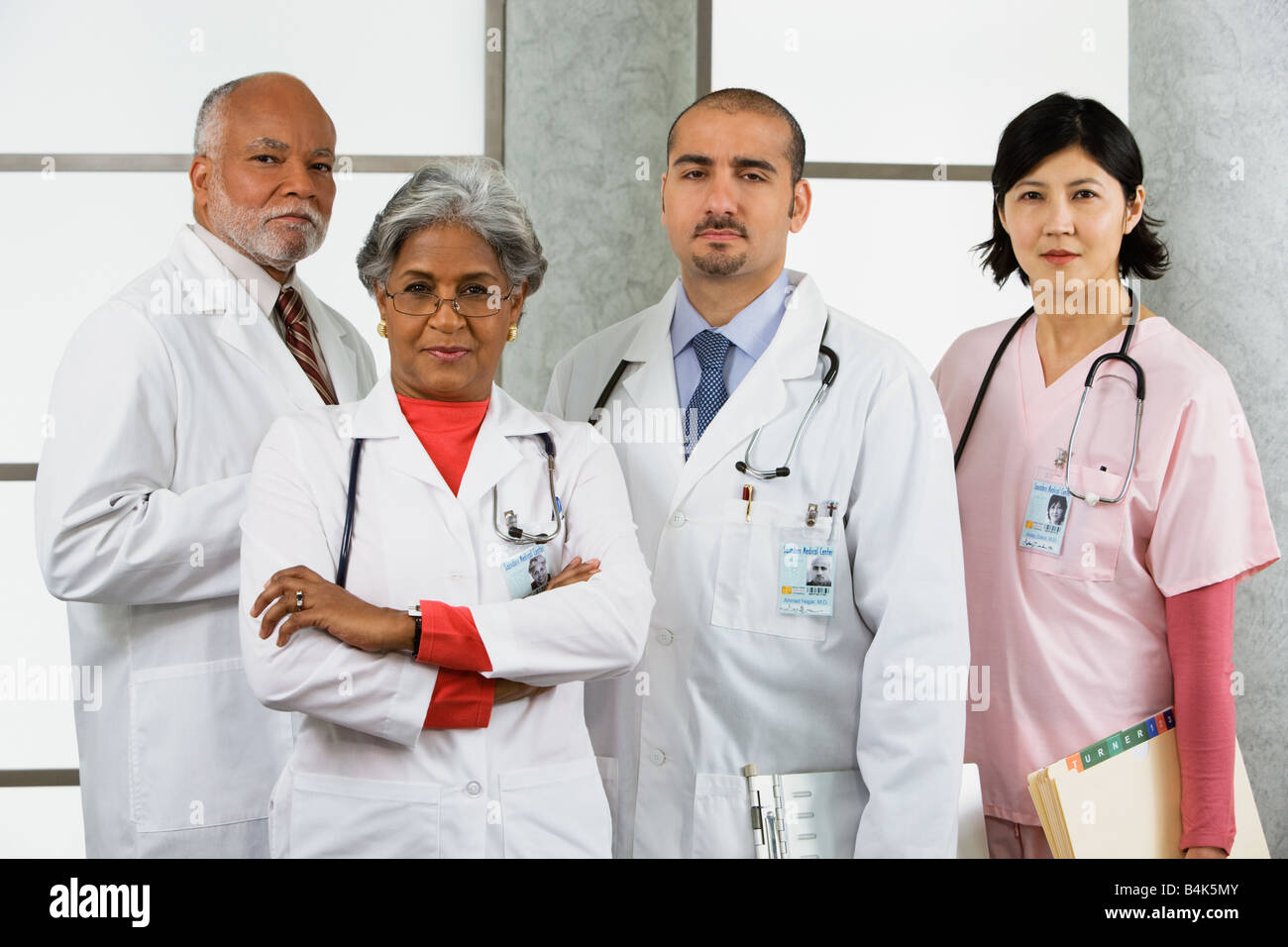 Multi-ethnic doctors and nurse posing Stock Photo - Alamy