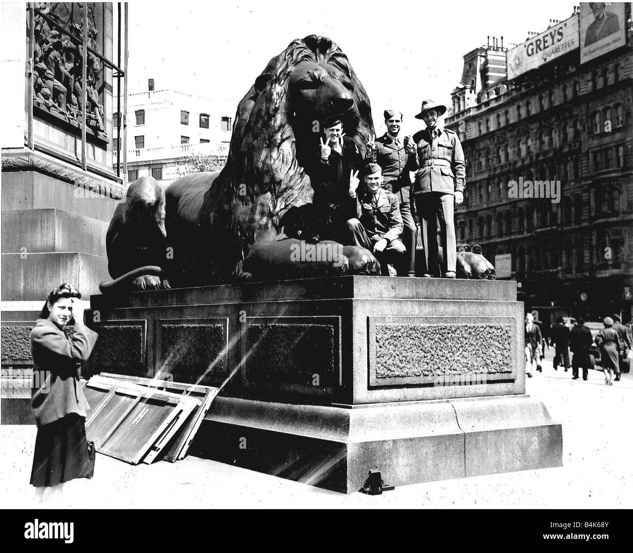 Soldiers on one of the lions in Trafalgar Square during WW2 VE Day ...