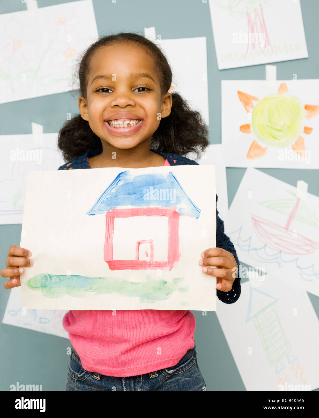 Mixed race girl holding water color painting of a house Stock Photo - Alamy