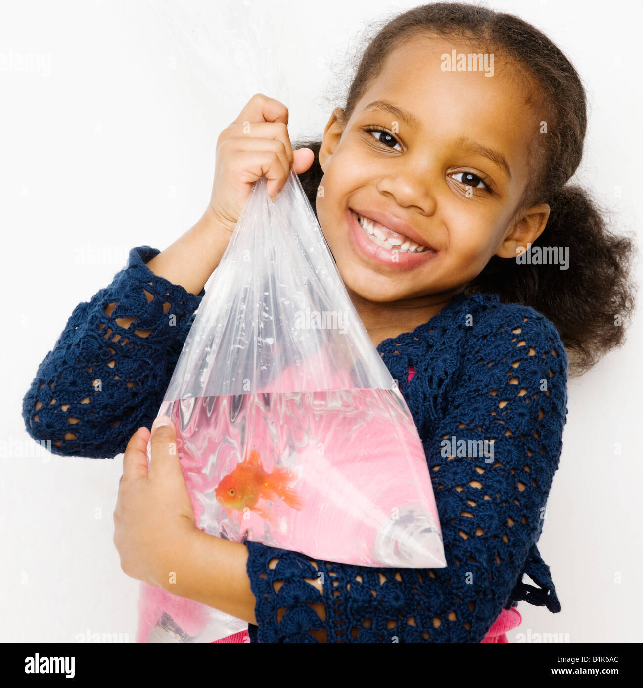 Girl with goldfish in white hi-res stock photography and images - Alamy