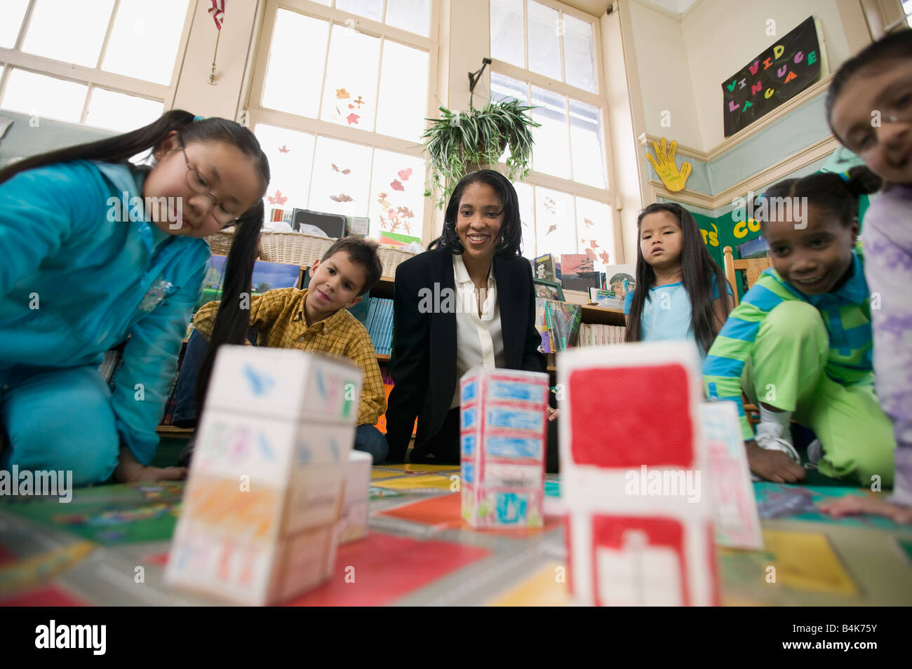 Multi-ethnic students in classroom with teacher Stock Photo - Alamy