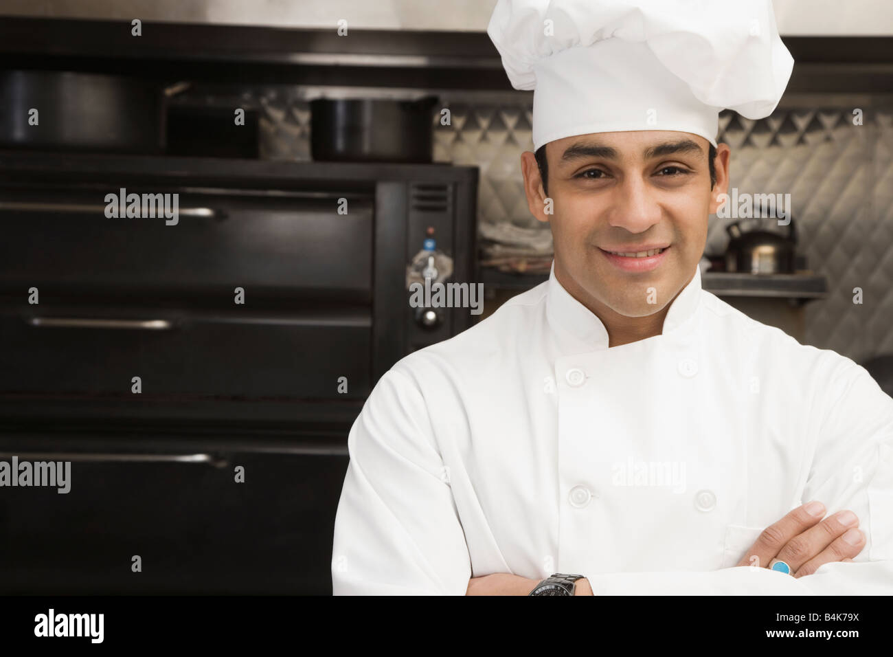 Hispanic male chef with arms crossed Stock Photo - Alamy