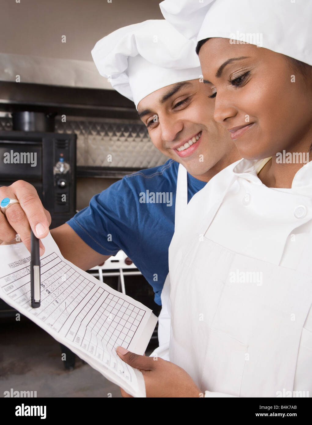 Happy woman chef looking orders hi-res stock photography and images - Alamy