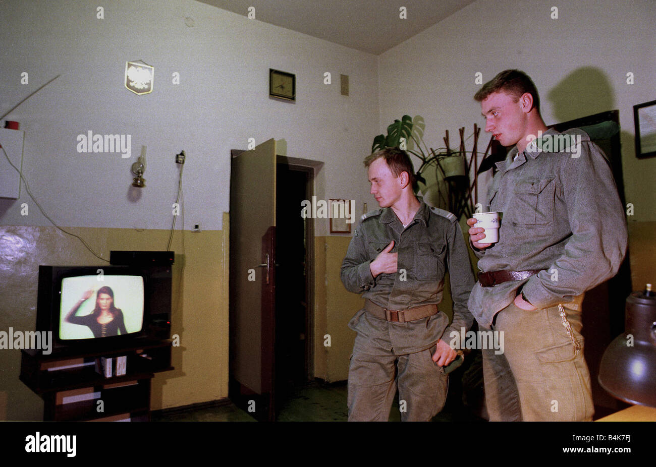 Border guard officers watching TV in the barracks during a night shift ...