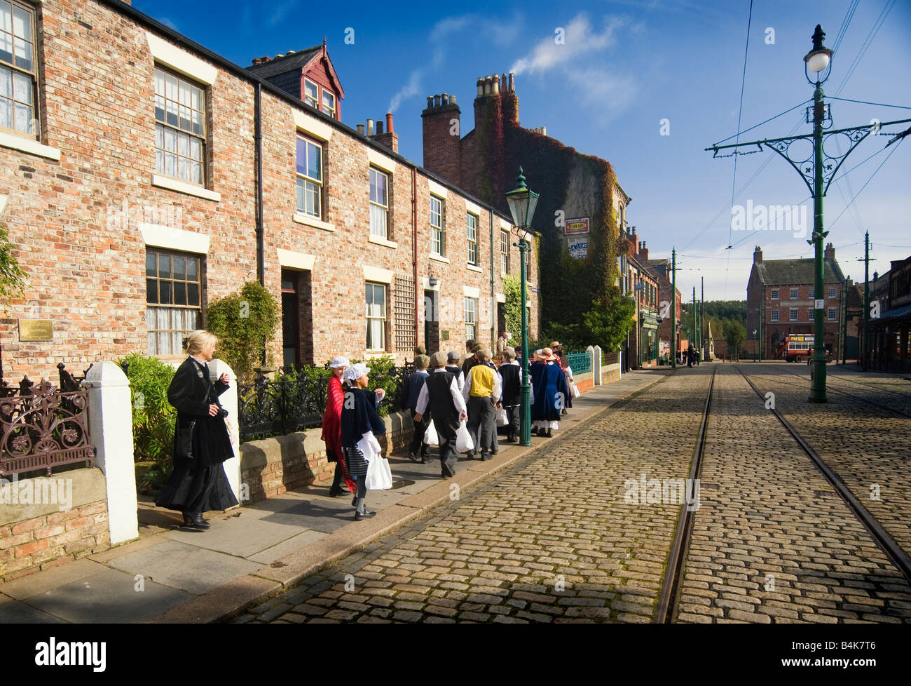 Edwardian street with children dressed in period costumes having a day ...