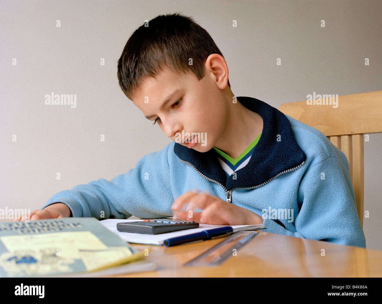 A young boy doing his homework Stock Photo - Alamy