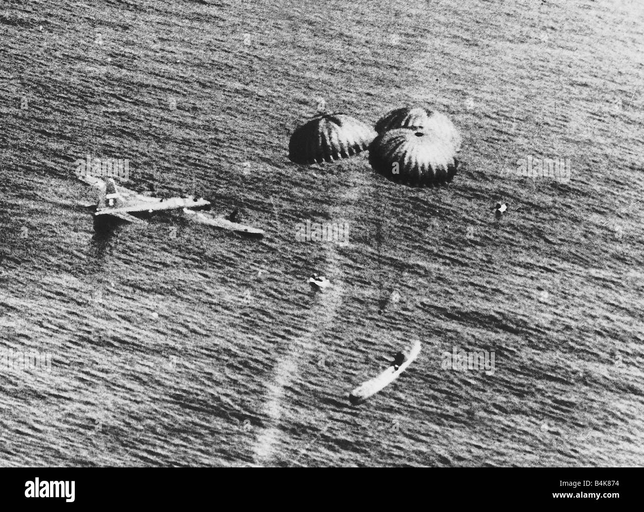 A crashed USAF Boeing B17 Flying Fortress floats on the sea as a ...