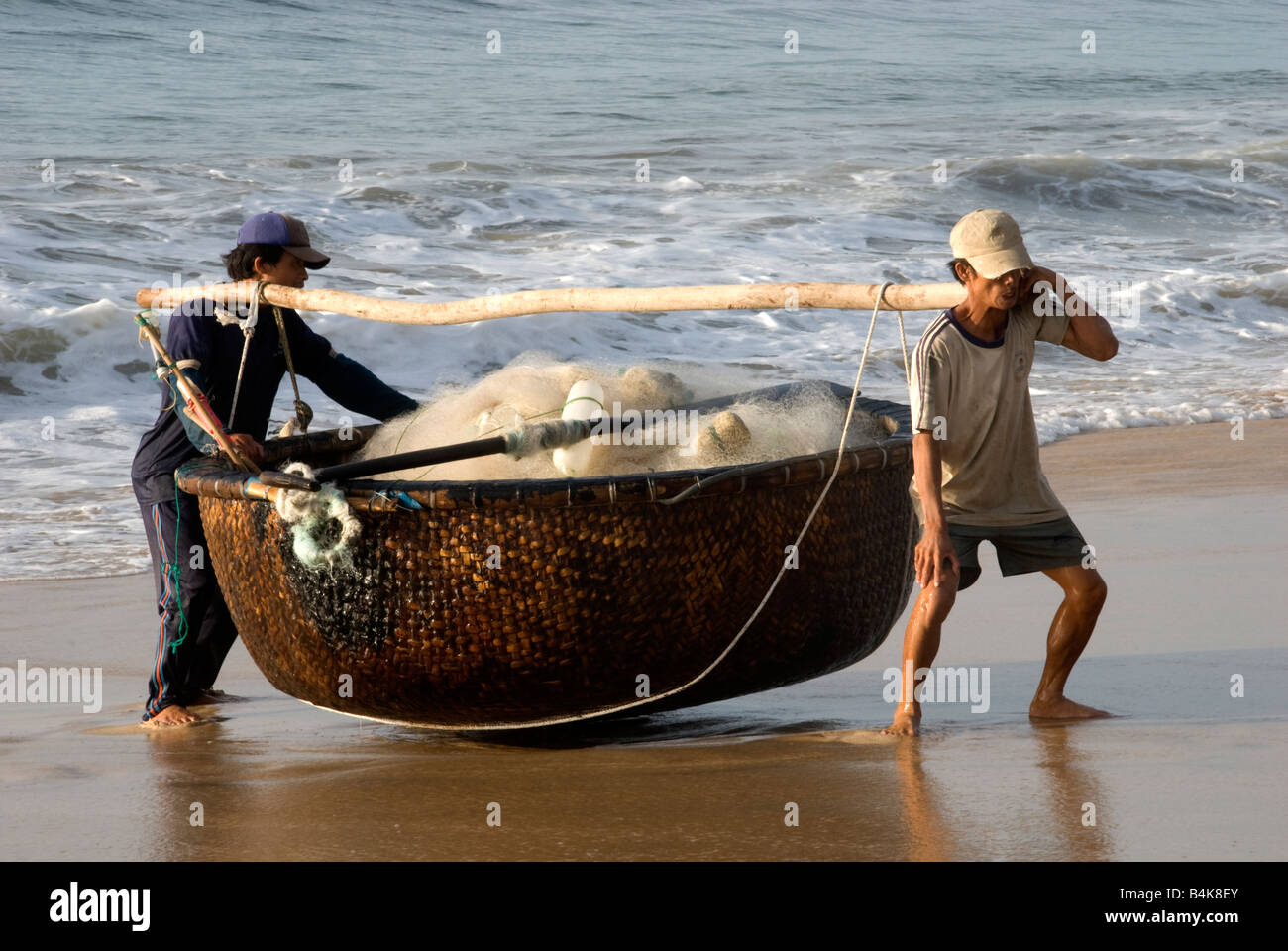 Coracle fishermen pulling in their line and net to see their catch on ...