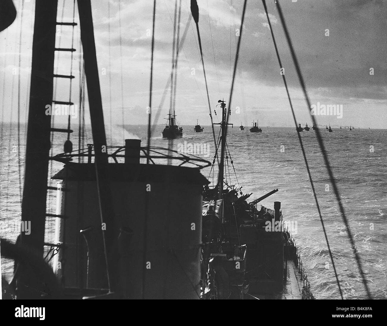 Convoy of ships with a destroyer escort crosses the Atlantic during WW2 ...