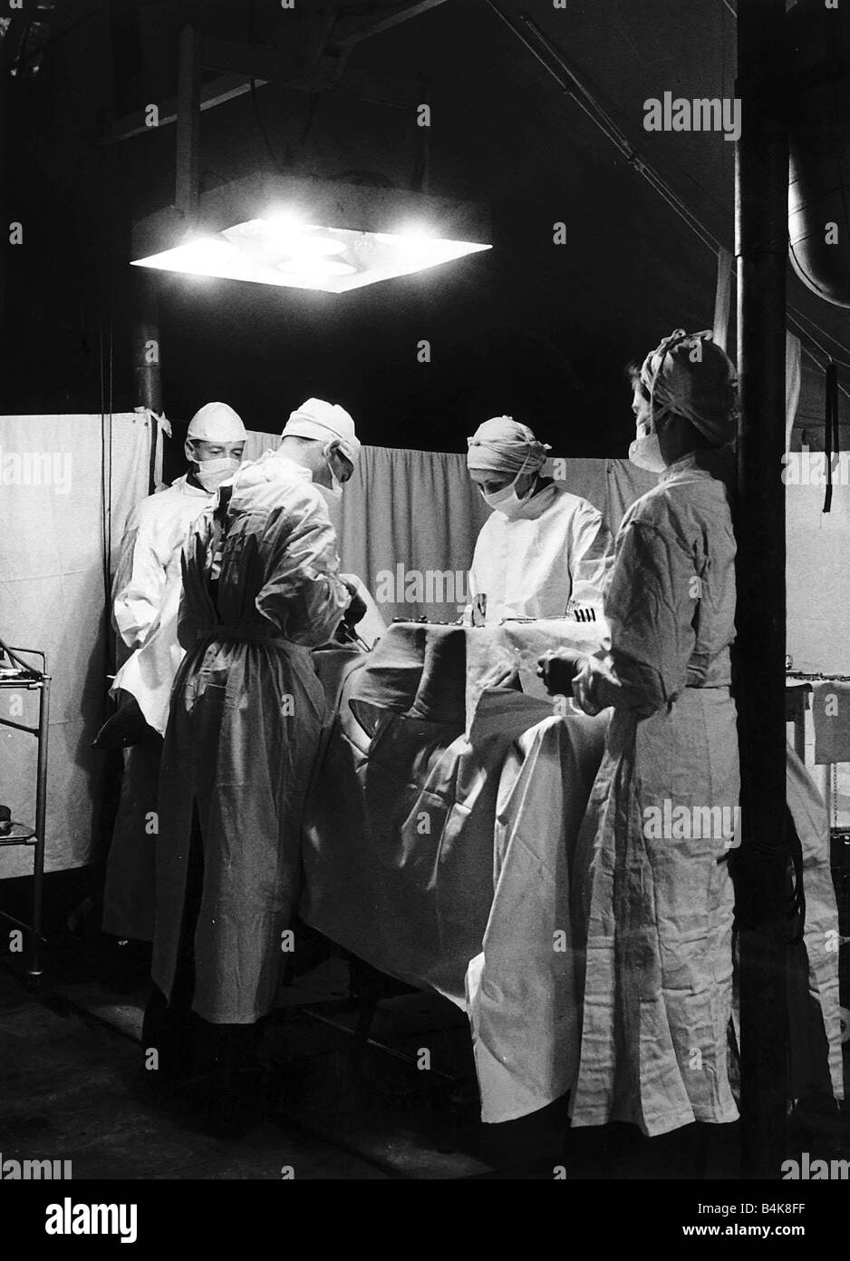 Doctors at work in the operating theatre of a field hospital in ...