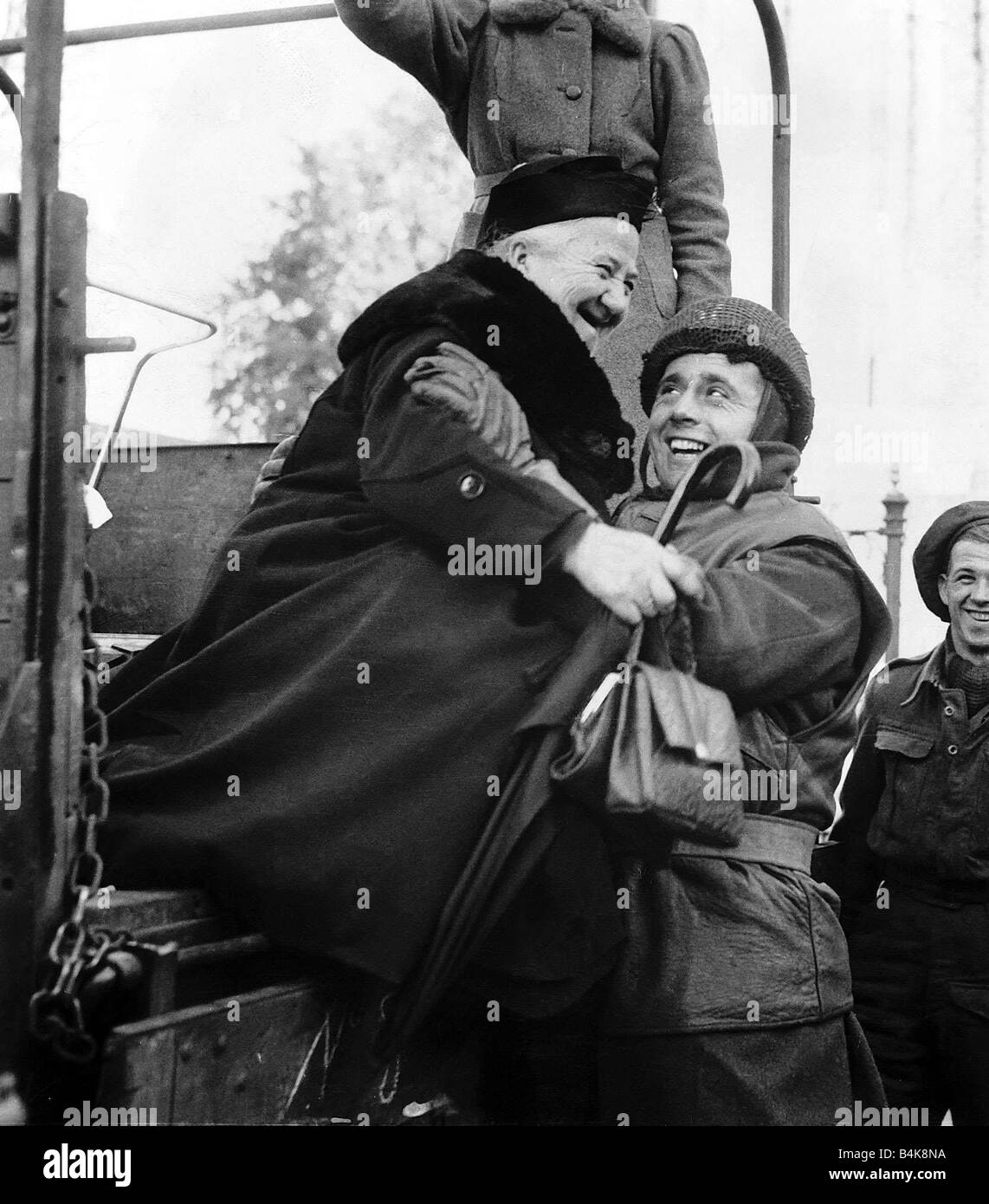 WW2 A British soldier helps an elderly Dutch evacuee down from an army ...