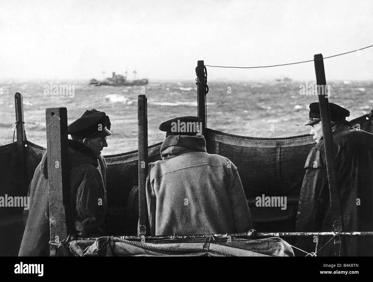 WW2 Captain and his crew keep watch from the bridge of a ship in an ...