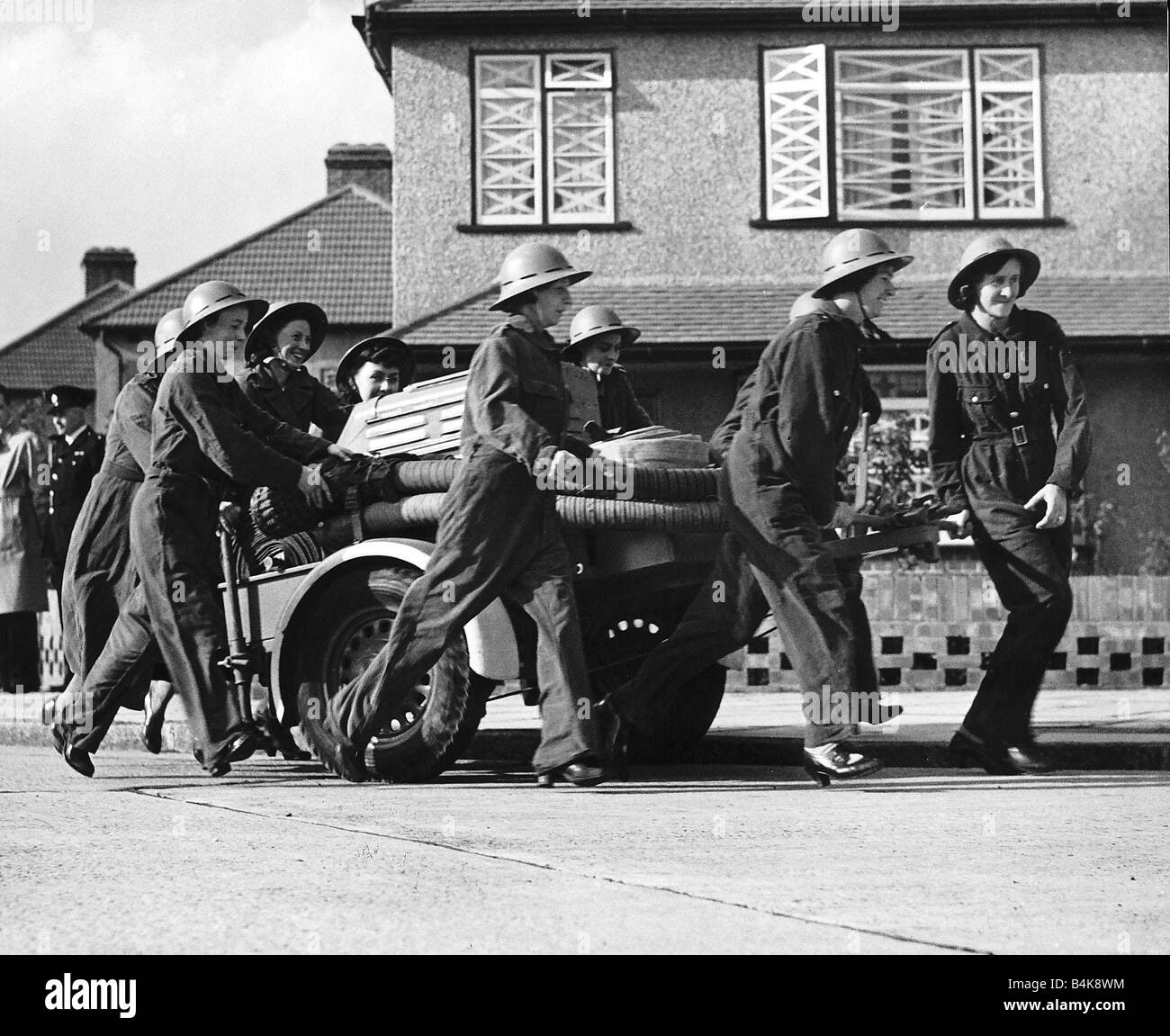 Women fire fighters from Erith Kent walk beside their trailer pump ...