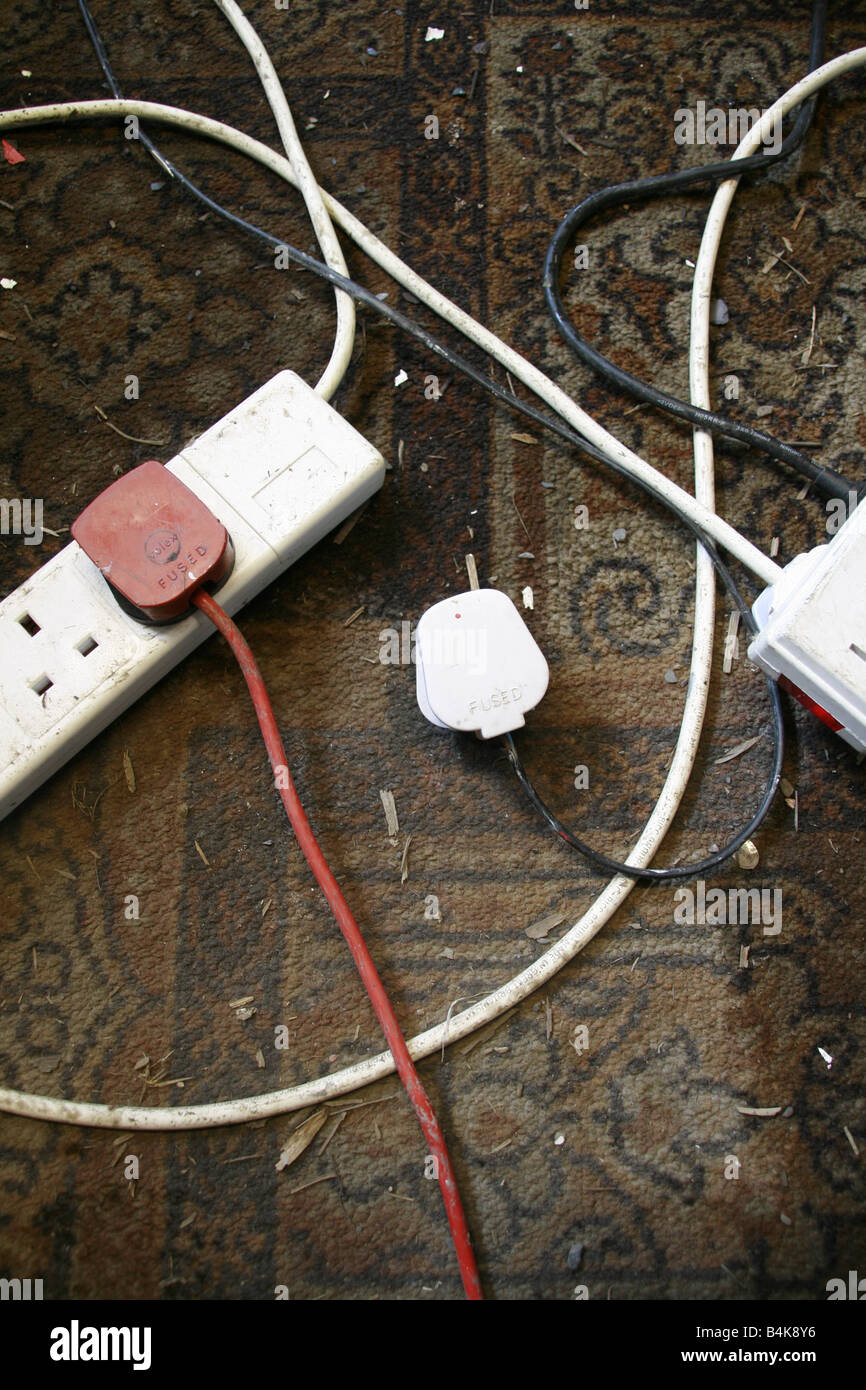 electricity plugs and extension lead dirty carpet Stock Photo - Alamy