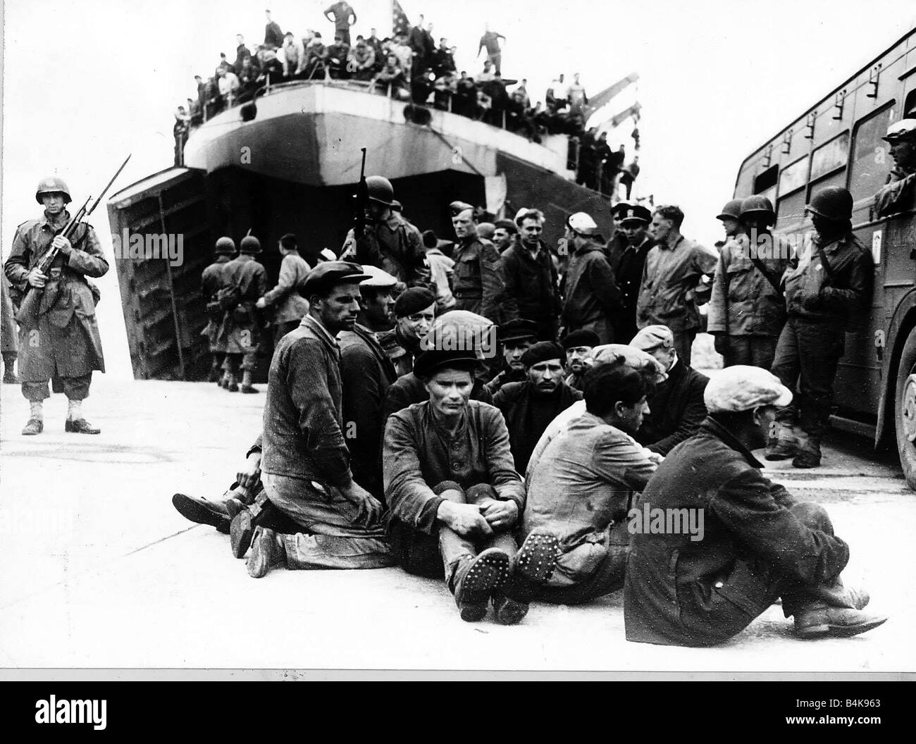 WW2 June 1944 Military police guard a group of French refugees who were ...