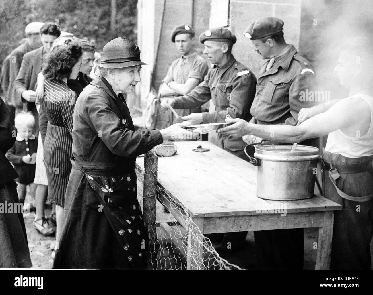 WW2 British troops serving refugees July 1944 in the liberated town of ...