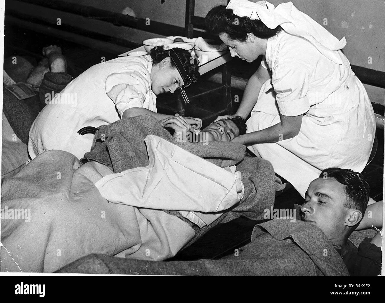 WW2 Doctor Ross Darby Jun 1944 operating on ear of blast deafened man ...