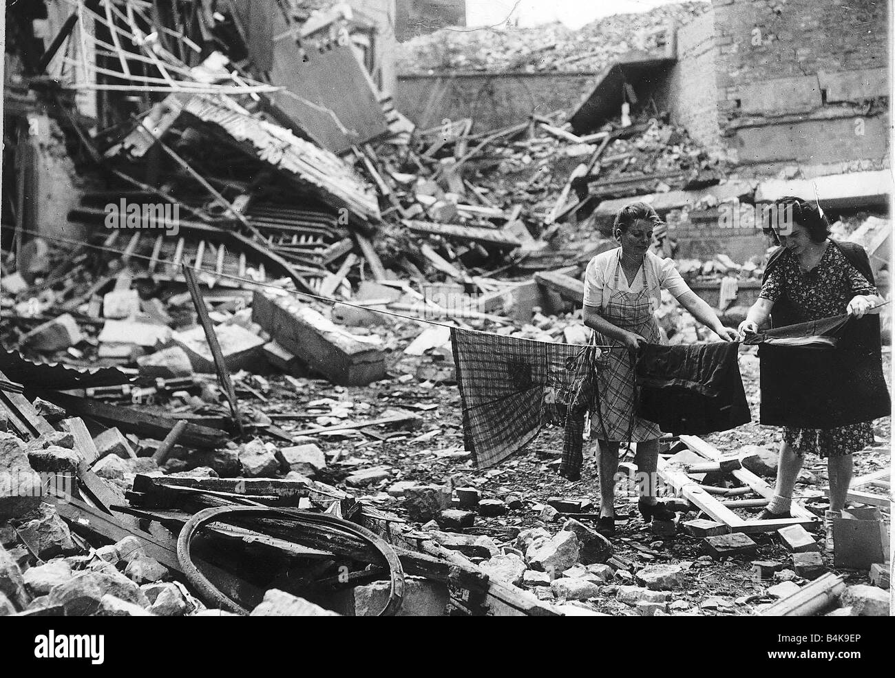 WW2 Women hanging out washing Jul 44 in Caen France amid bombed ruins ...