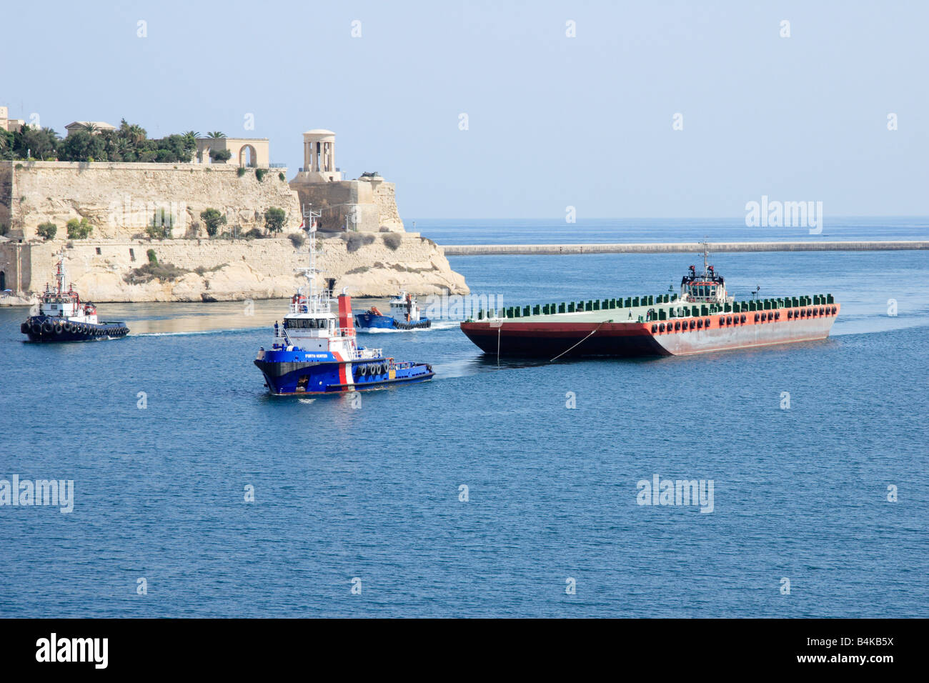 Tug Boats assisting a large floating platform into the Grand Harbour ...