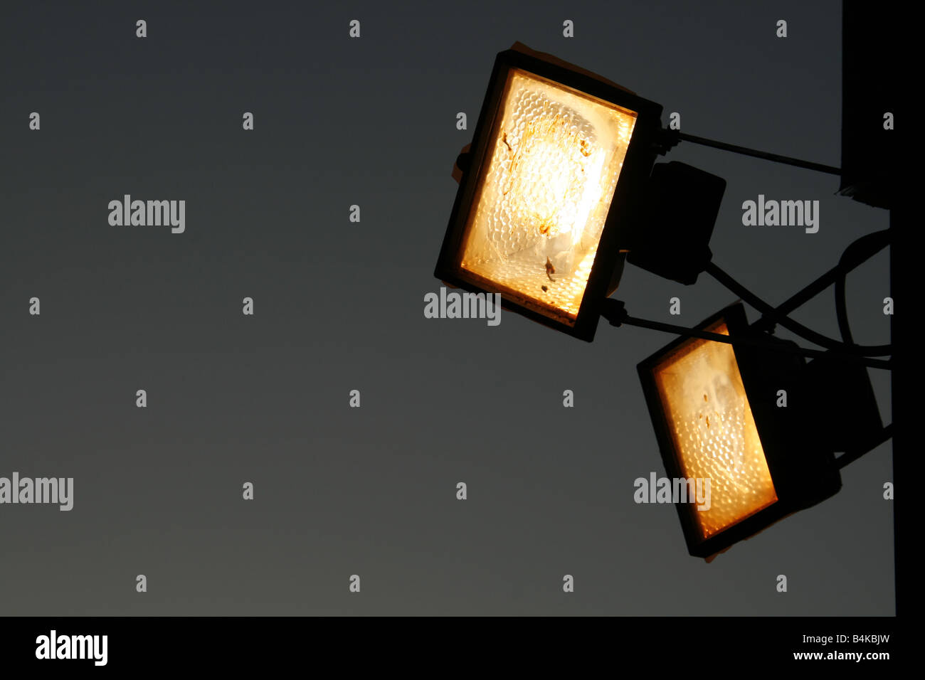 two security lights on building side wall at night Stock Photo - Alamy