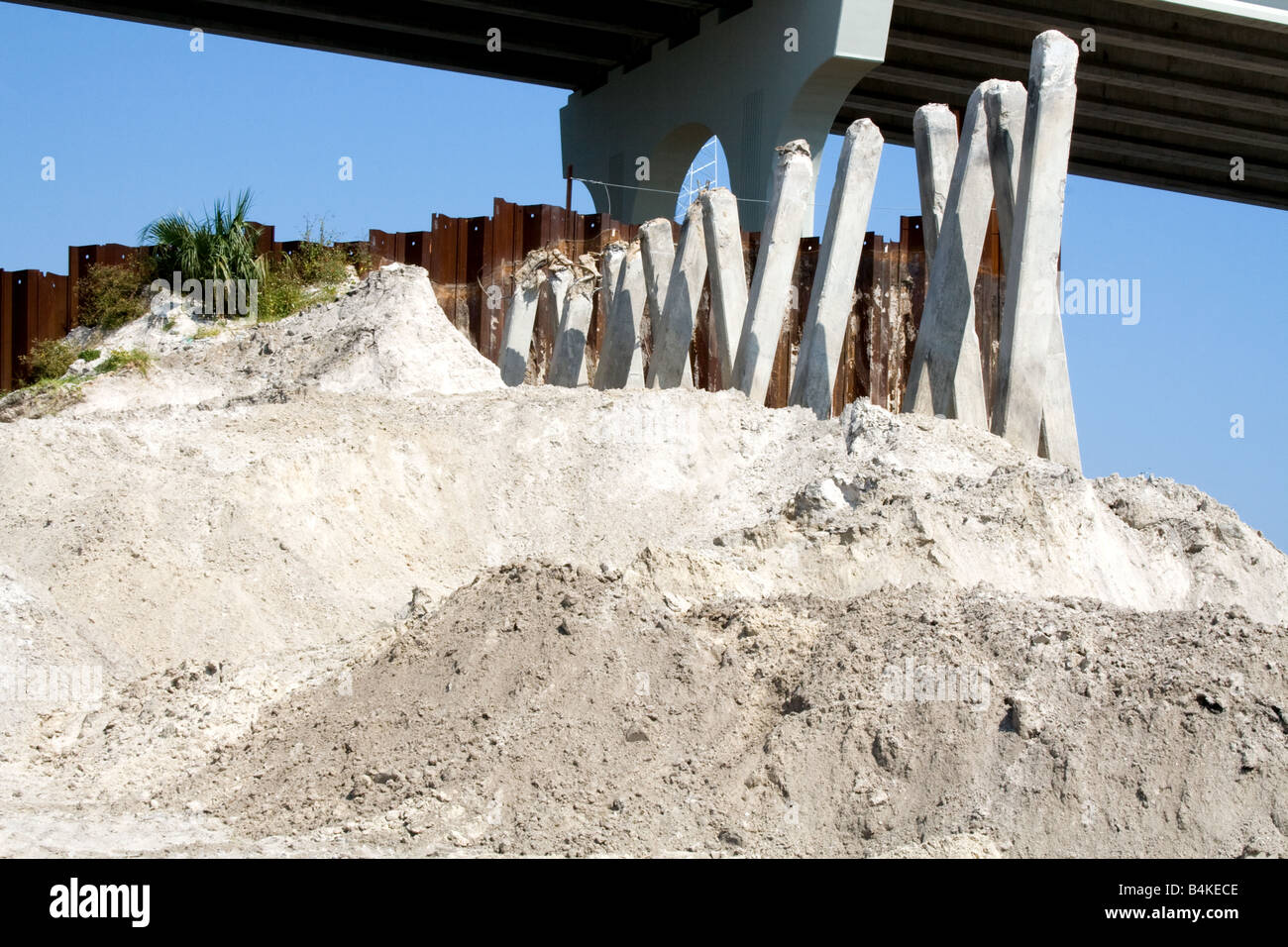 Bridge struts atop a pile of sand underneath a sturdy bridge Stock ...