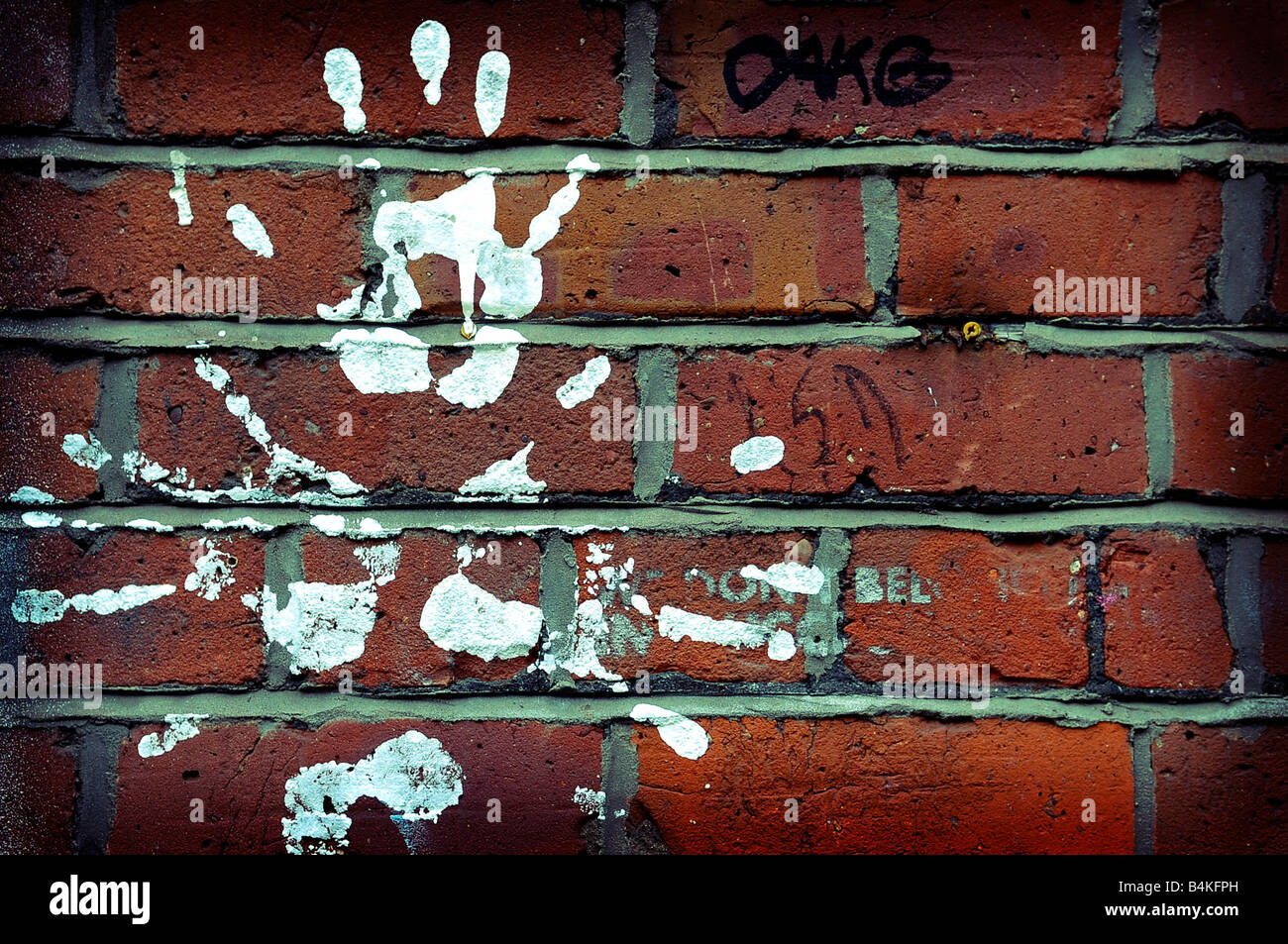 white paint handprints red brick wall art graffiti Stock Photo - Alamy