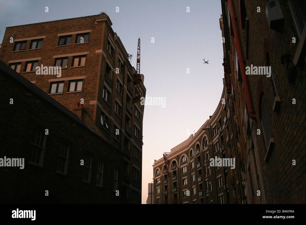 A Plane flies over Gun Wharf in Wapping, London England UK Stock Photo ...