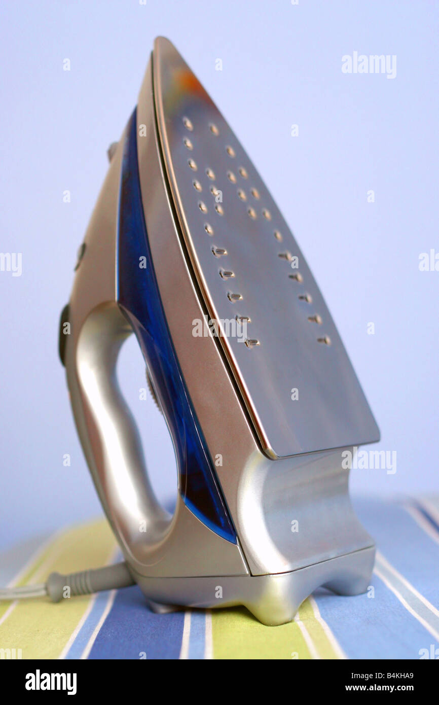 Closeup detail of a common iron sitting on an ironing board Stock Photo ...