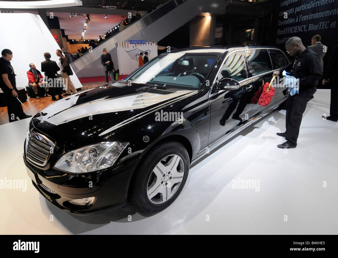 A cleaner polishing a luxury Mercedes limousine during the "Mondial de ...