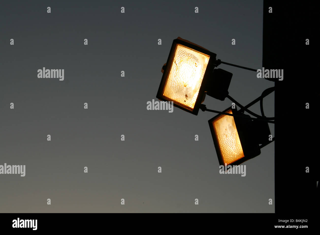 two security lights on building side wall at night Stock Photo - Alamy