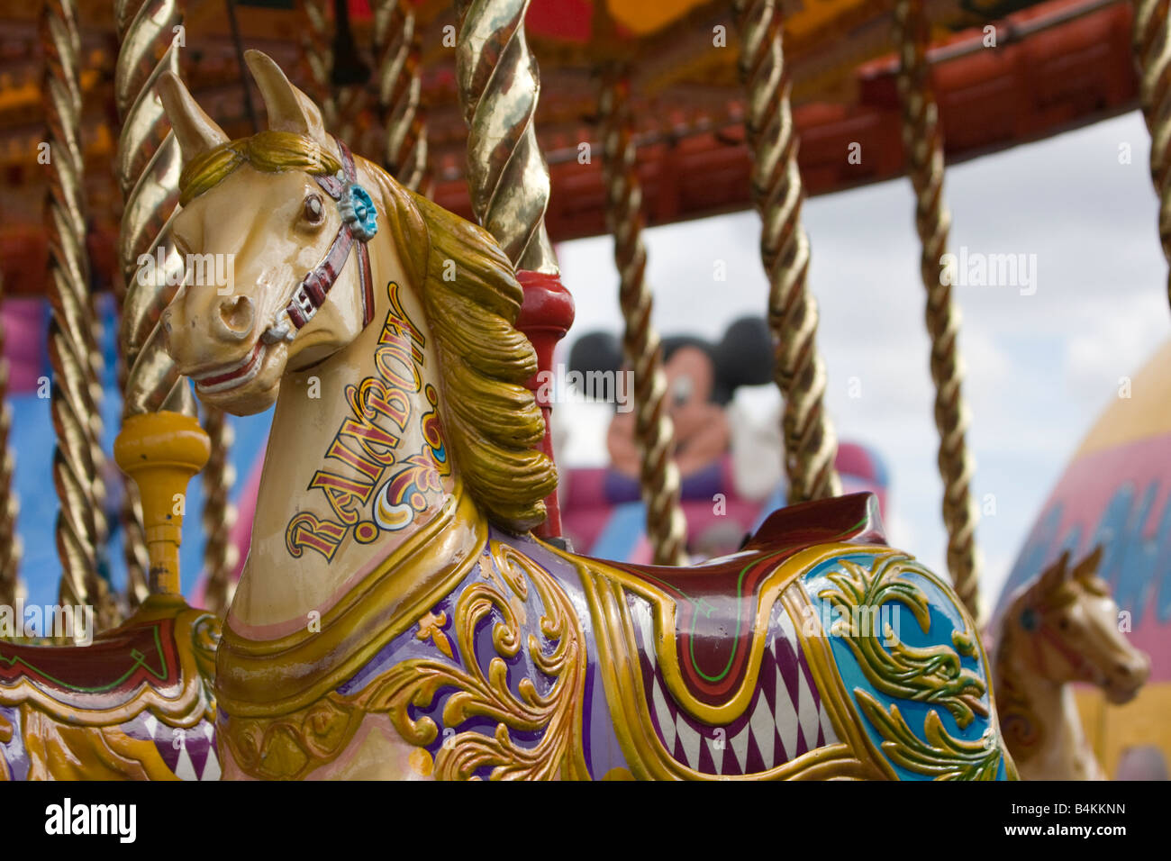 Carousel horses with mickey mouse in the background Stock Photo - Alamy