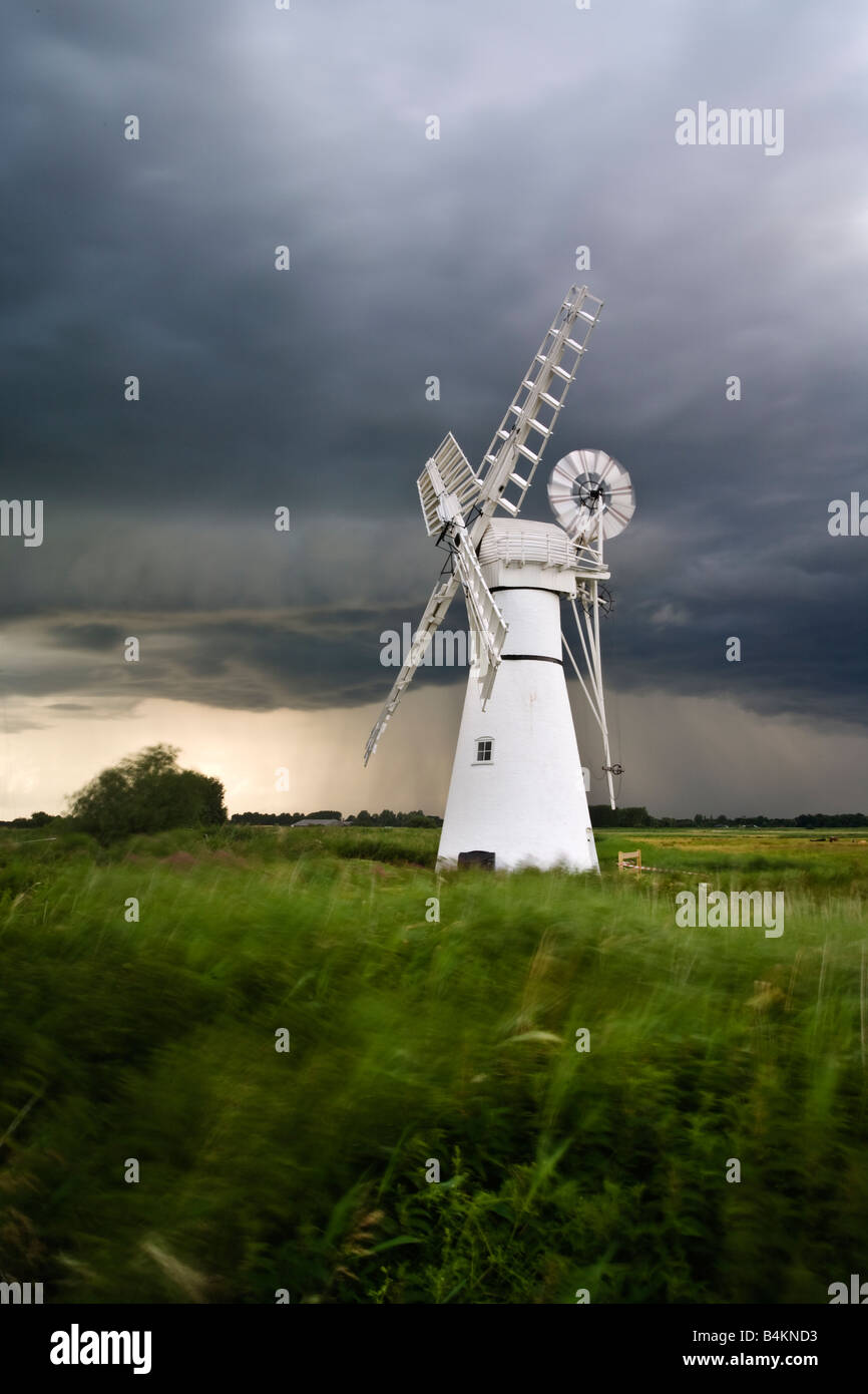 The white painted structure of Thurne Mill during a storm on the ...