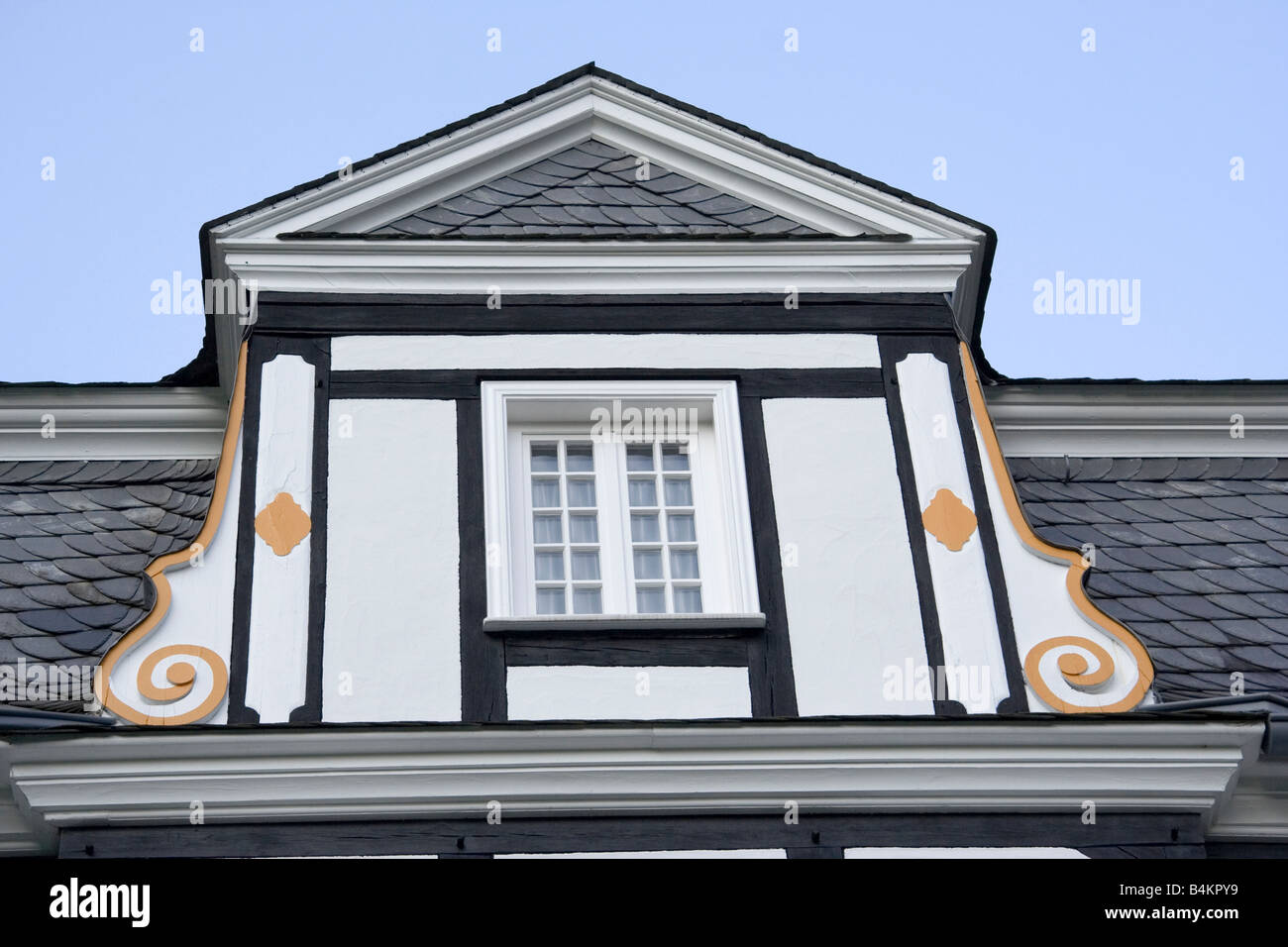 dormer window of a halftimbered mansion with slated roof with ornaments ...