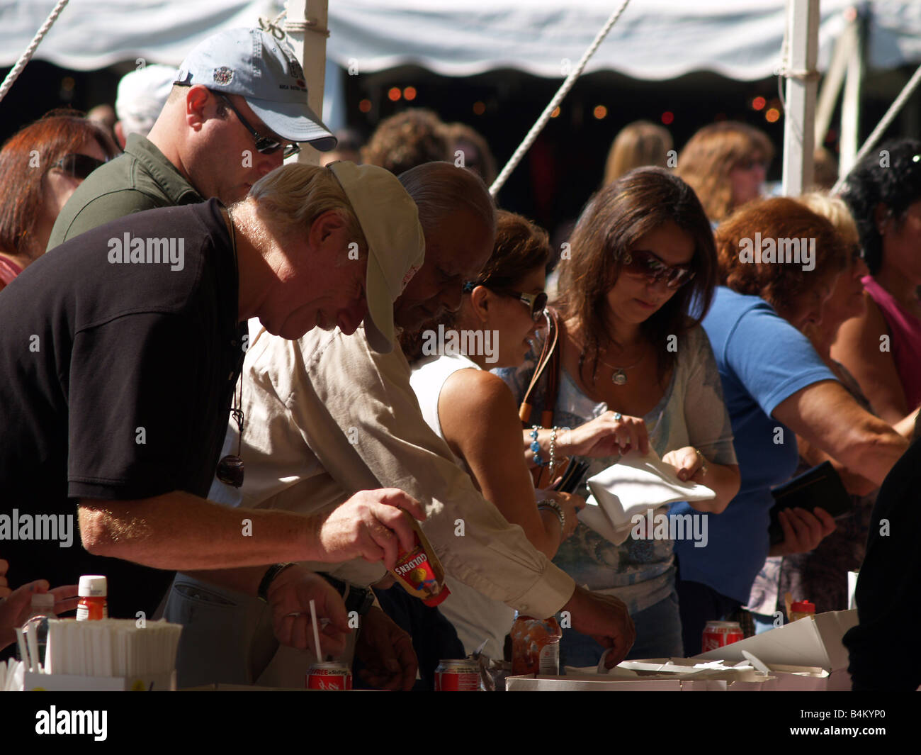 Crowd of people at the food tent at an arts and crafts fair in New York ...