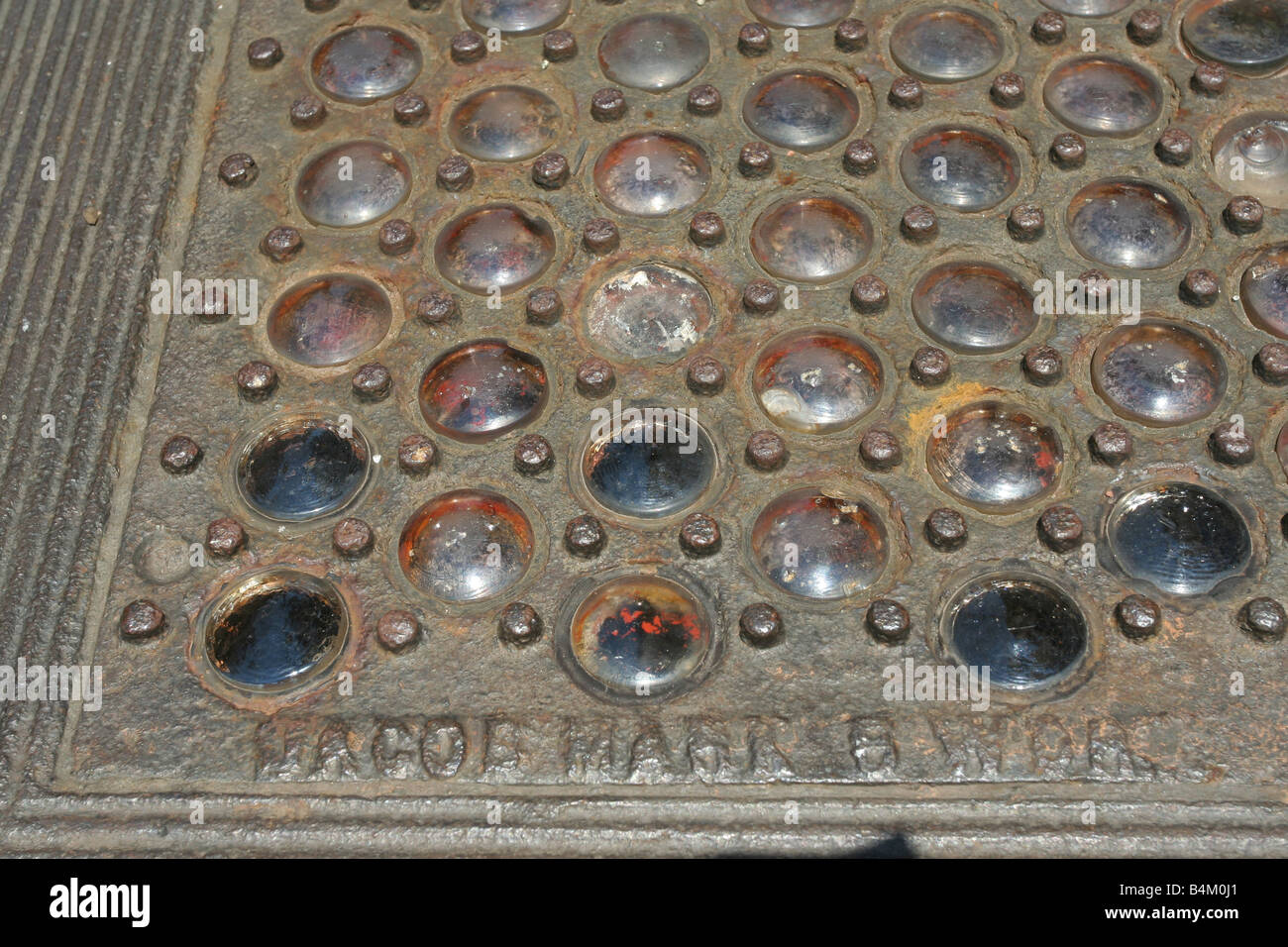 A New York City cast-iron sidewalk vault embedded with colorful glass ...