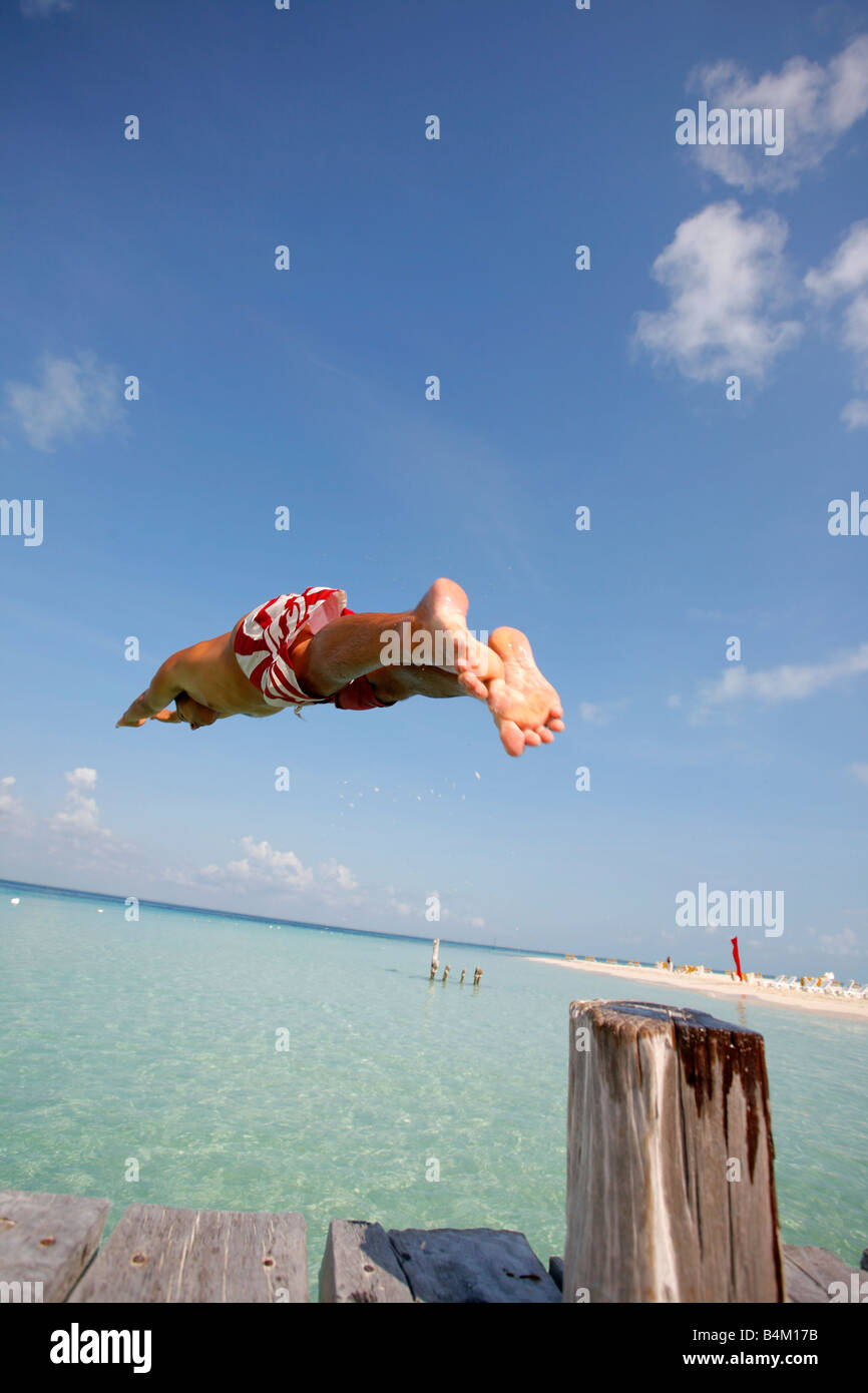 Man jumping into the sea Stock Photo - Alamy