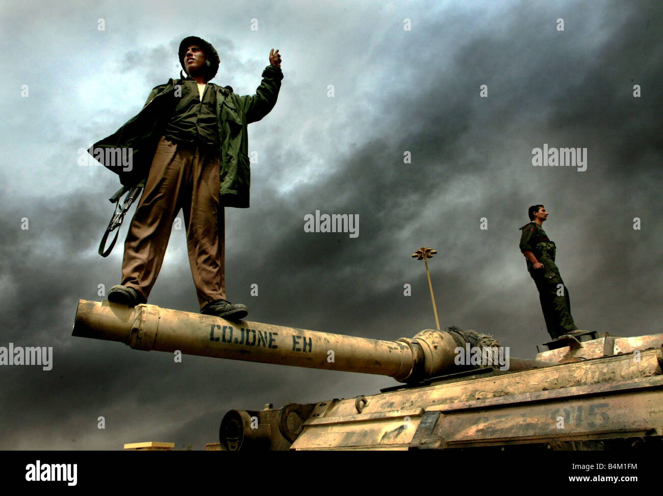 Iraq War 2003 Baghdad An Iraqi soldier stands proudly on the barrel of ...