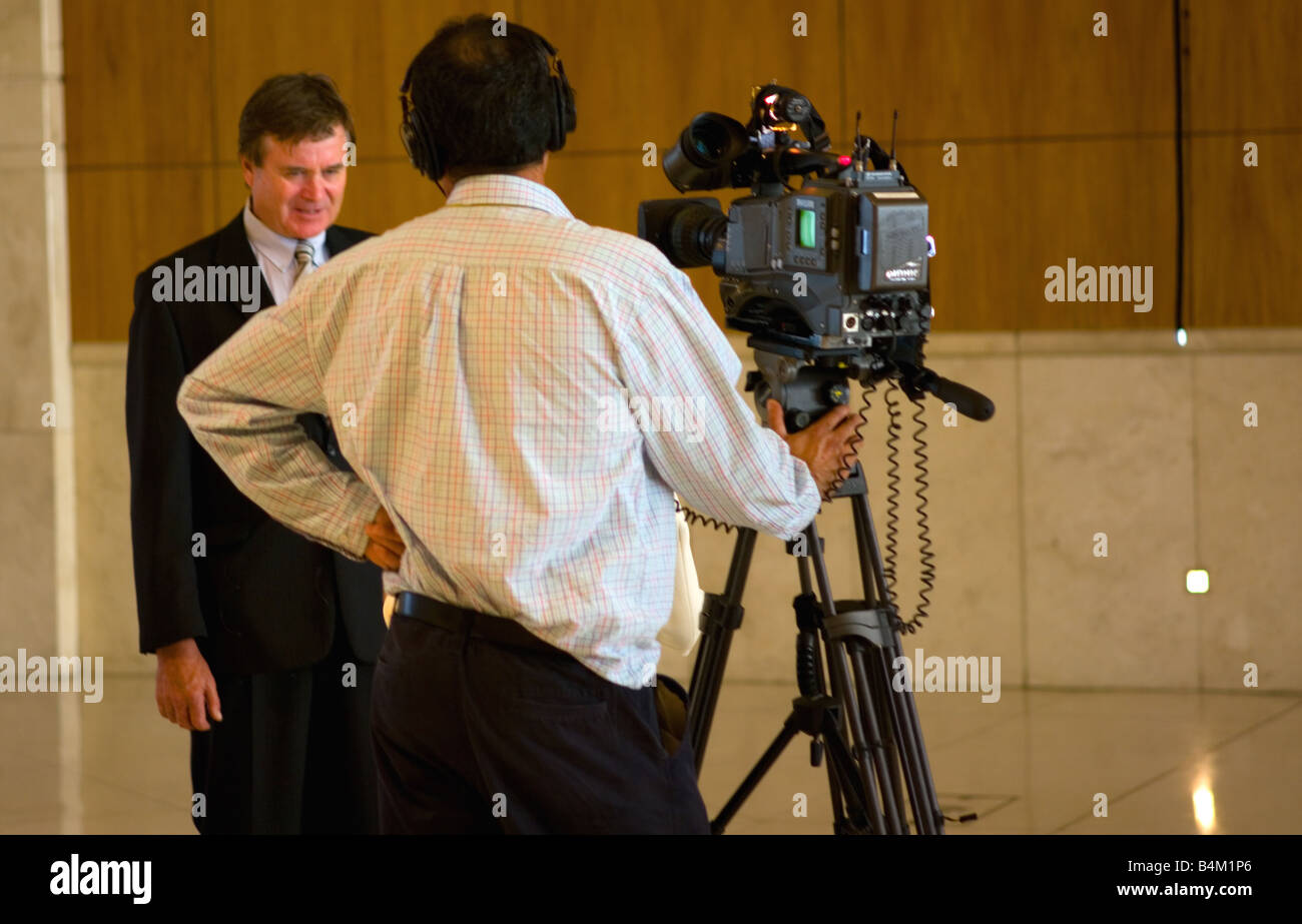 Camera man and journalist at the stock exchange Stock Photo - Alamy