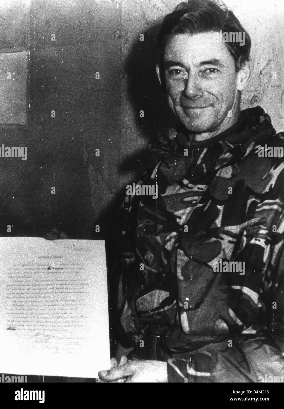 Major General Jeremy Moore holds the surrender document signed by ...